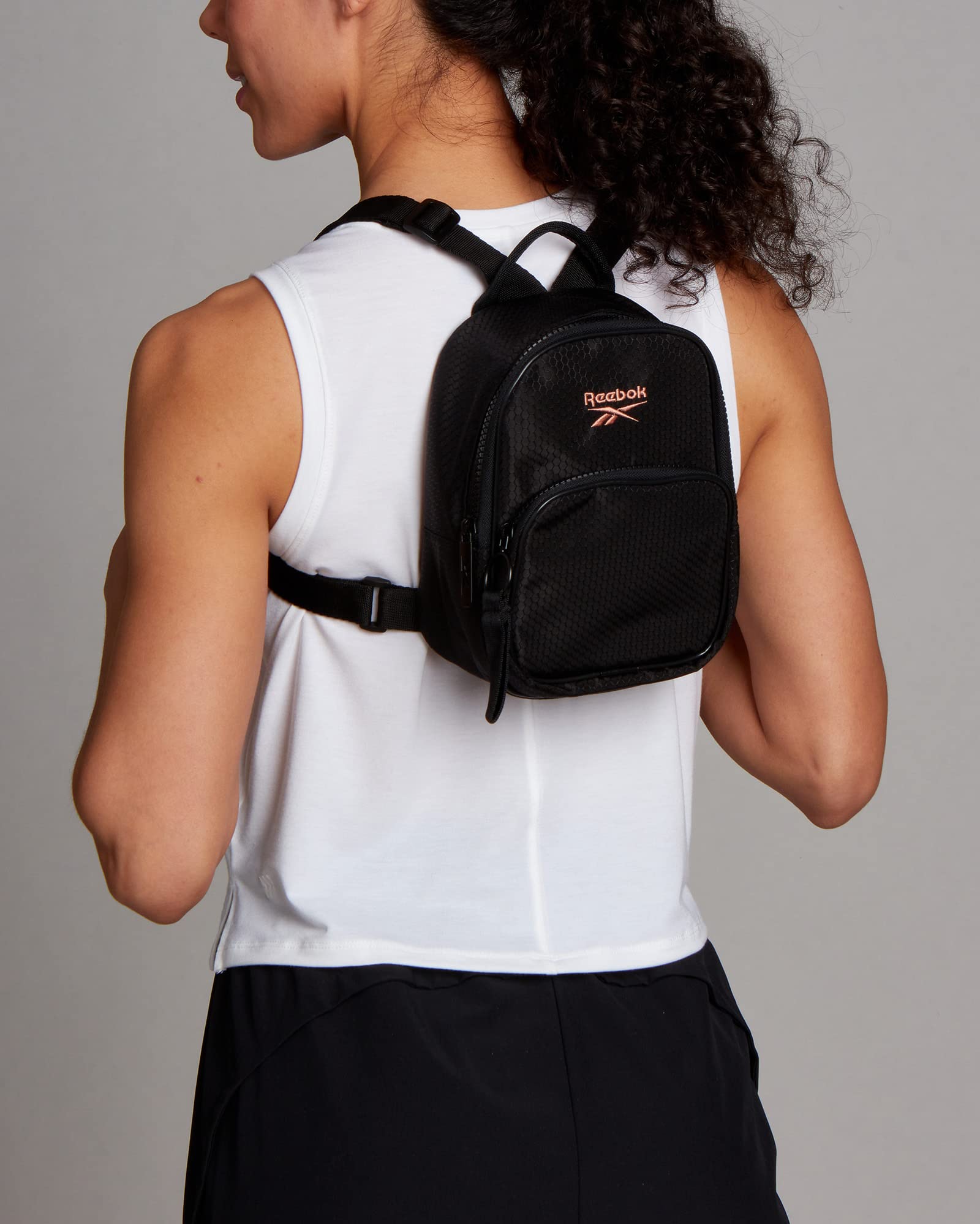 Reebok Women's Backpack - Lightweight Mini Essential Backpack - Small Casual Travel Bag, Black With Rose Gold Logo