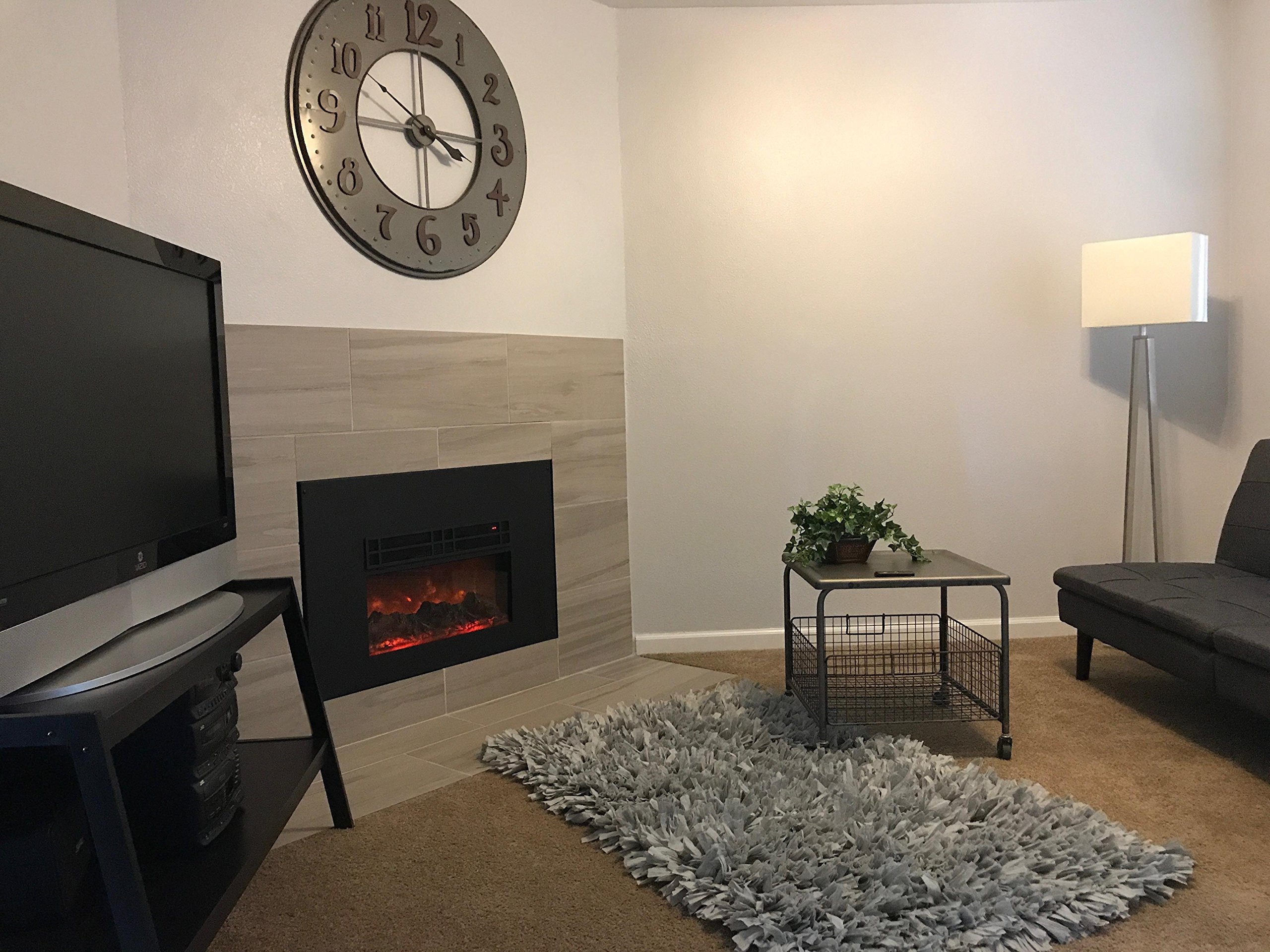 AA Warehousing Y-Décor True Flame electric fireplace insert by 30" with front surround