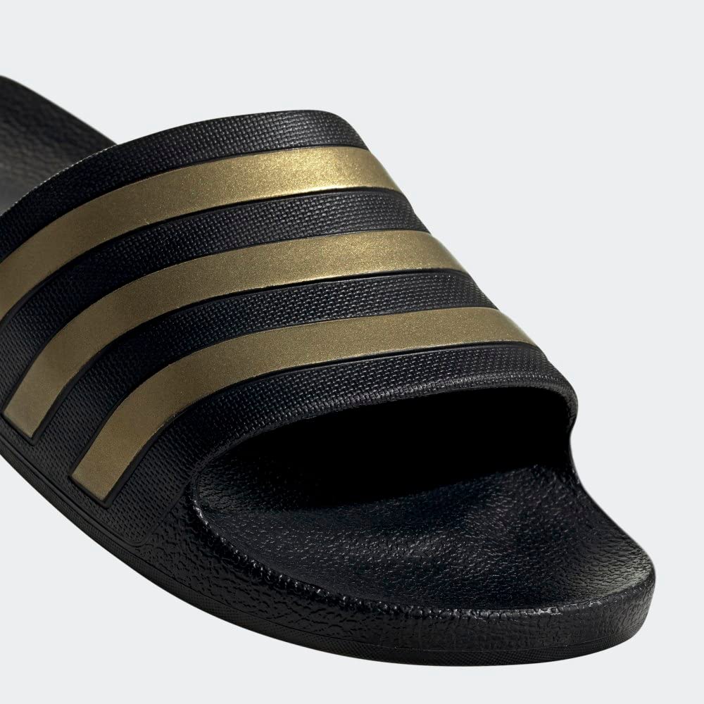 adidas unisex adult Adilette Aqua Slide Sandal, Core Black/Gold Metallic/Core Black, 11 Women Men US
