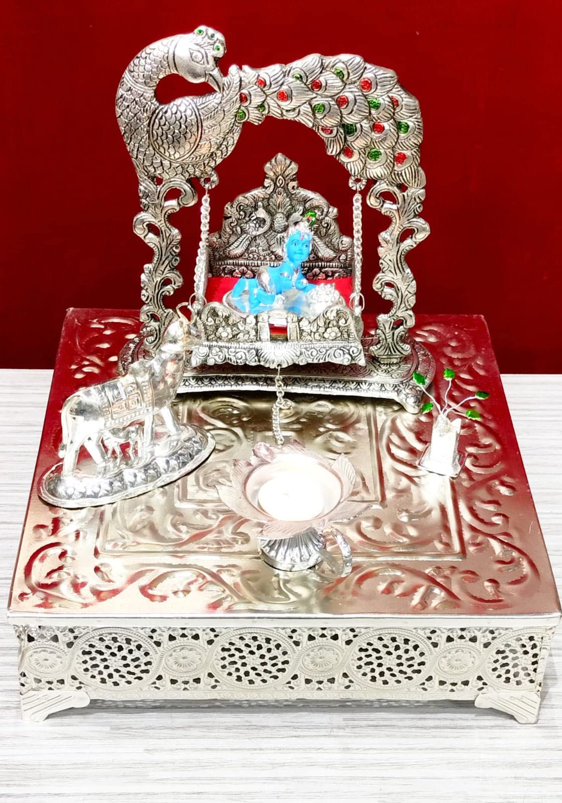 Crafting with Love a Beautiful Little Krishna Peacock jhula with German Silver chowki + Cow Calf + tulsi Plant + Lotus Handle Diya