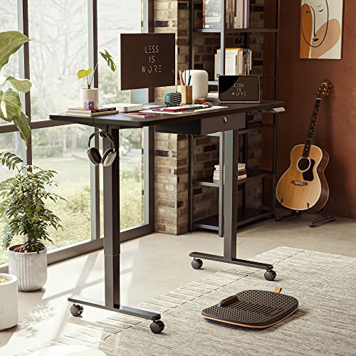 FEZIBO 55 x 24 Inches Standing Desk with Drawer, Adjustable Height Electric Stand up Desk, Sit Stand Home Office Desk, Ergonomic Workstation Black Steel Frame/Black Tabletop