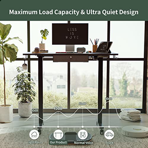 FEZIBO 55 x 24 Inches Standing Desk with Drawer, Adjustable Height Electric Stand up Desk, Sit Stand Home Office Desk, Ergonomic Workstation Black Steel Frame/Black Tabletop