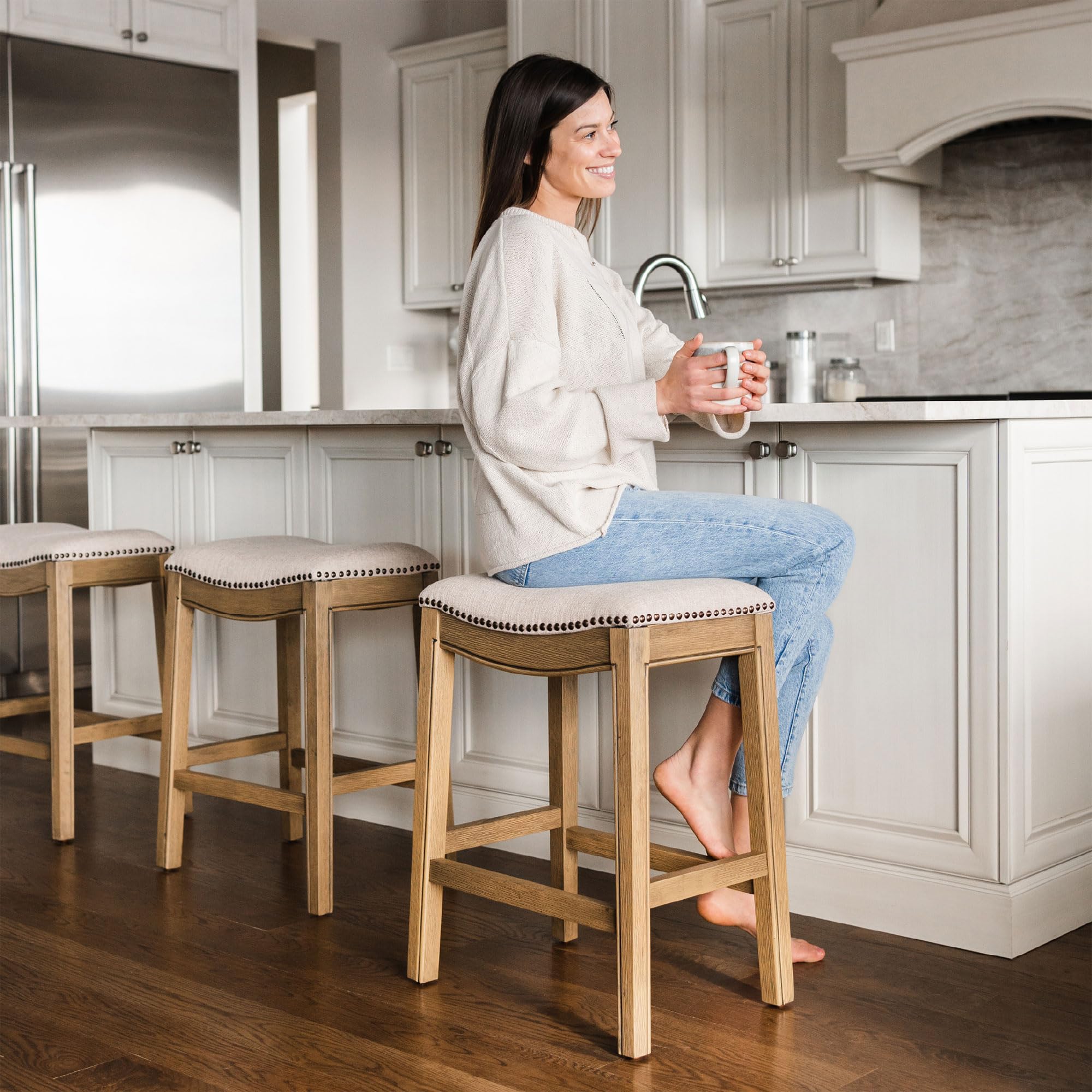 Maven Lane Adrien 26 Inch Counter Height Upholstered Backless Saddle Barstool in Natural Wood Finish with Wheat Cream Fabric Cushion Seat