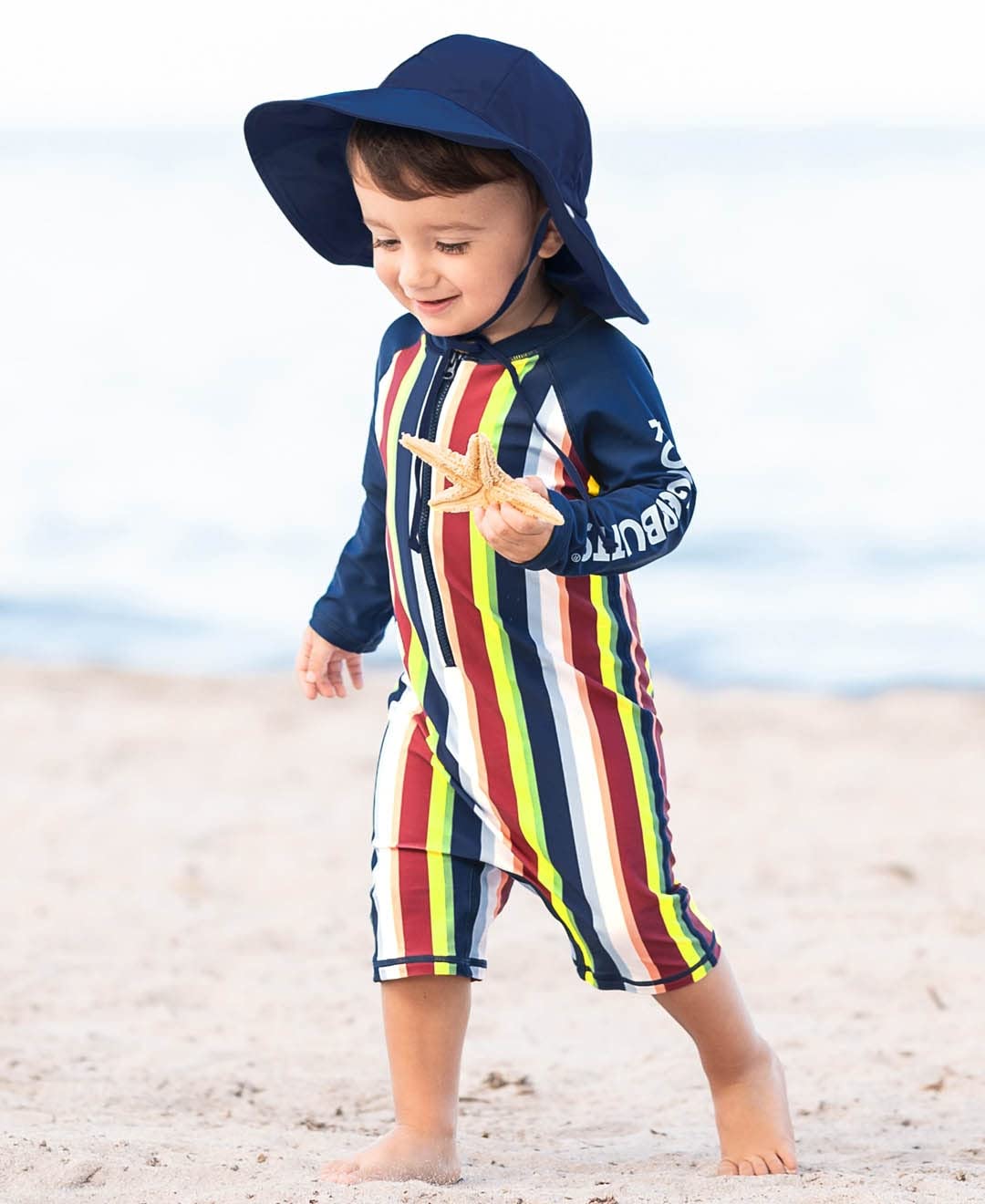 RUGGEDBUTTS Baby/Toddler Boy Swimsuit, One Piece Zipper Rash Guard Sunsuit with UPF 50+ Sun Protection - Sunset Stripe - 12-18m