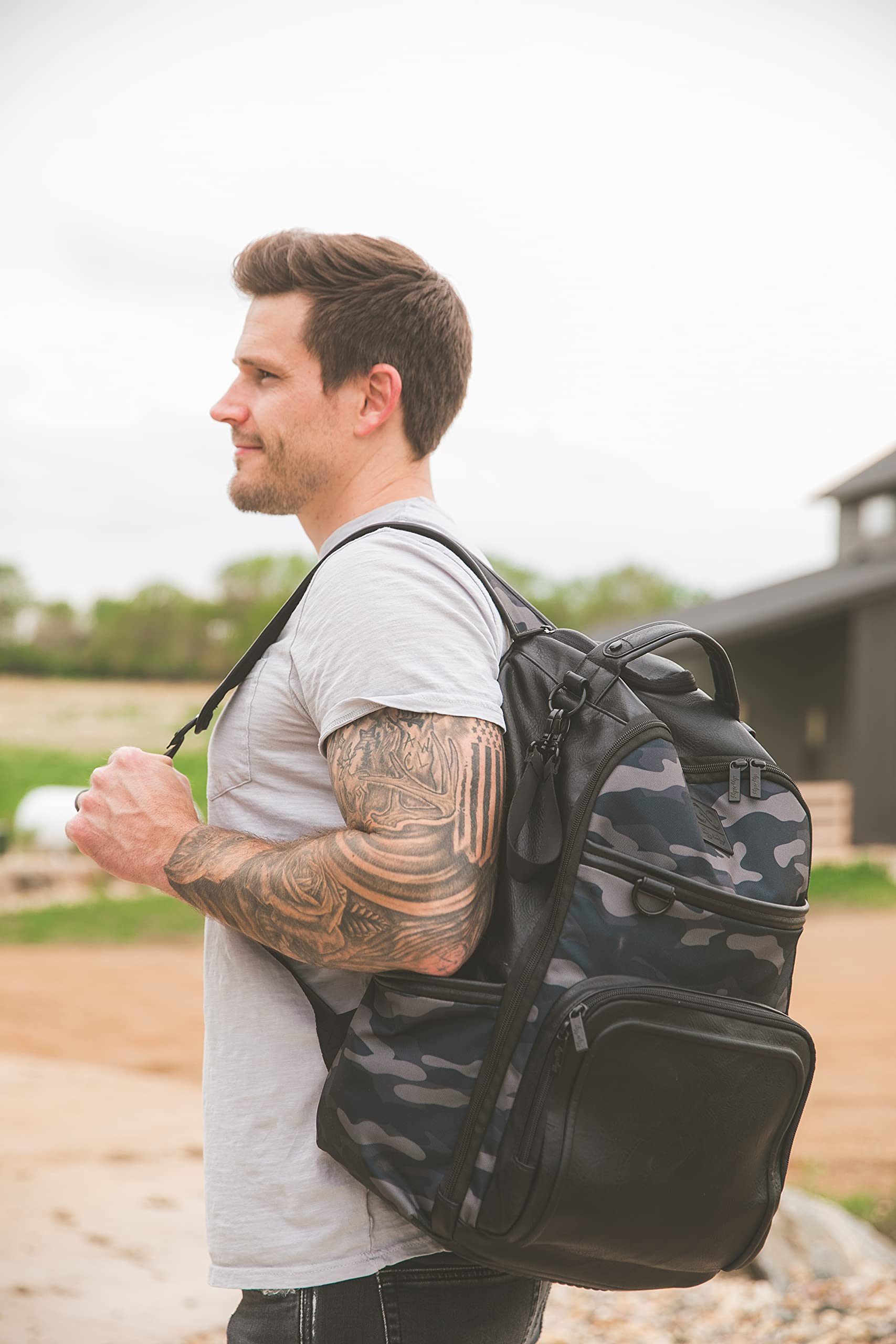 Itzy Ritzy Chelsea + Cole Diaper Bag Backpack - Large Capacity Boss Backpack Diaper Bag; Includes Changing Pad, Stroller Clips and Tassel, Camo with Stag Head Print Interior and Black Hardware