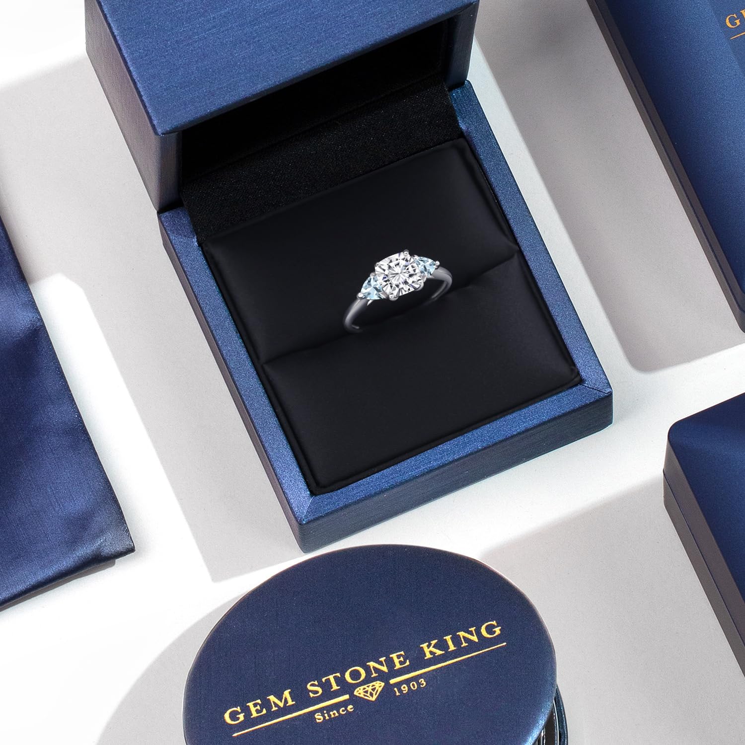 10K White Gold White Moissanite from Charles & Colvard and Sky Blue Aquamarine 3-Stone Engagement Ring For Women (2.11 Cttw, 7MM Cushion and 4MM Trillion, Available In Size 5, 6, 7, 8, 9)