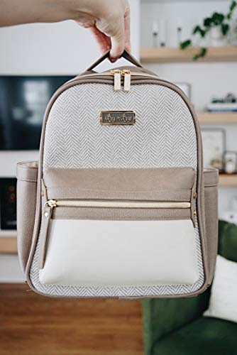 Itzy Ritzy Mini Diaper Bag Backpack β Chic Mini Diaper Bag with Changing Pad, 8 Total Pockets (4 Internal and 4 External), Grab-Top Handle and Rubber Feet (Vanilla Latte)