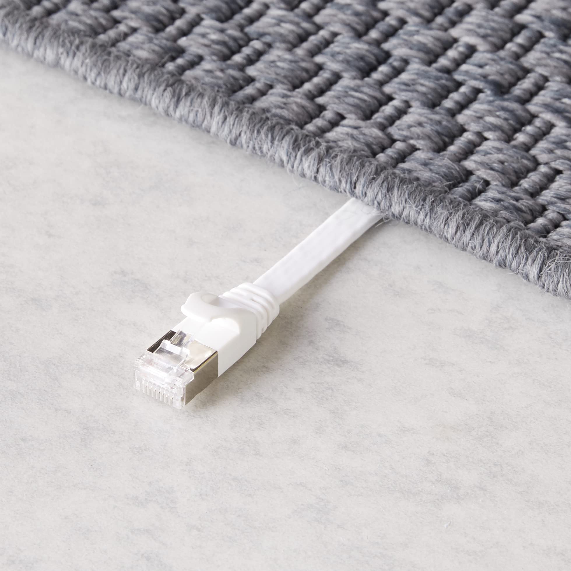Amazon Basics RJ45 Cat 7 Ethernet Patch Cable, Flat, 600MHz, Snagless, Includes 15 Nails, 30 Foot, White