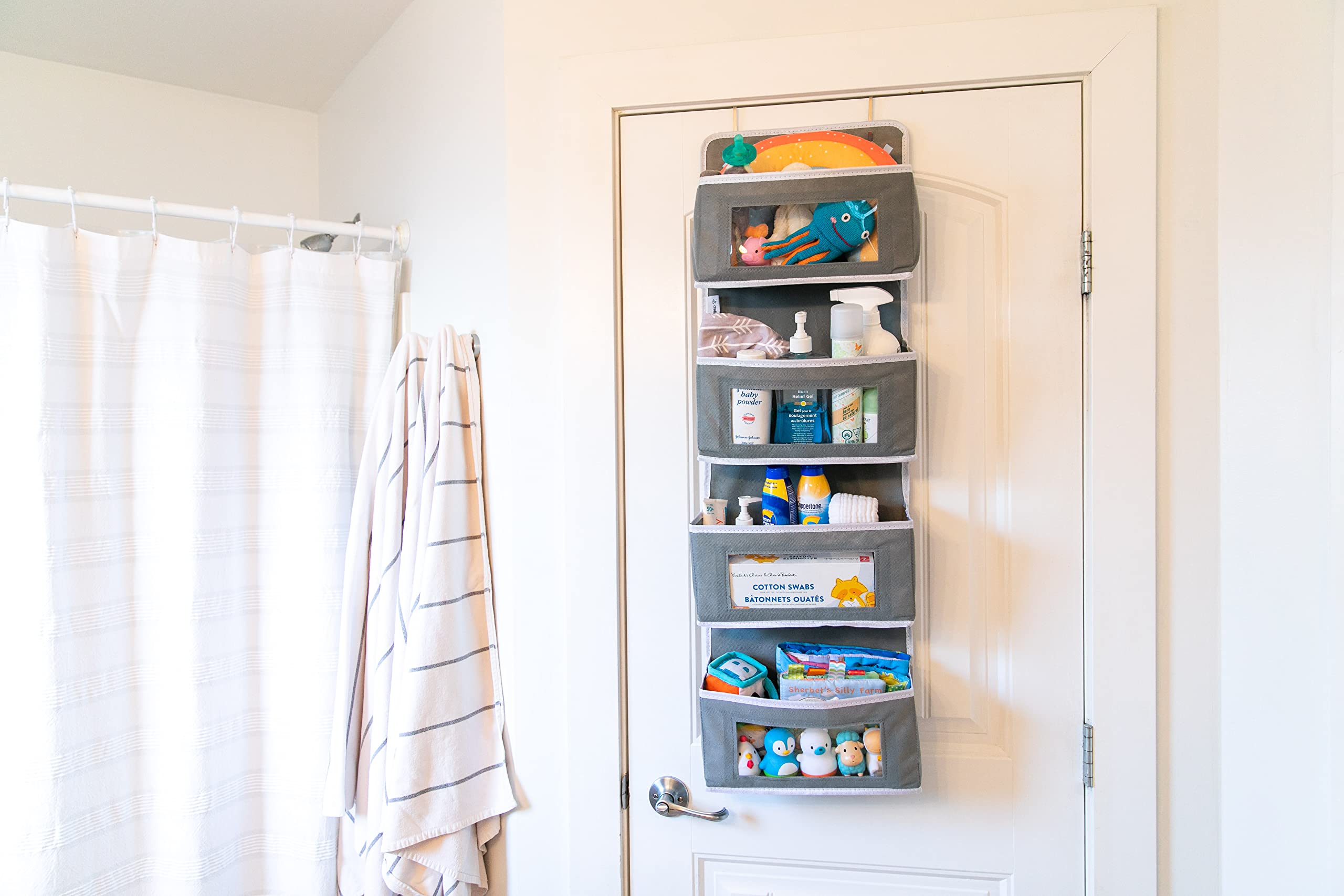 Cradle Essentials Over Door Hanging Organizer | Storage Caddy for Newborn and Baby Items, Stuffed Animals | Large Pockets with Clear Windows for Nursery, Mudroom, Bathroom, Laundry, Pantry, Closet