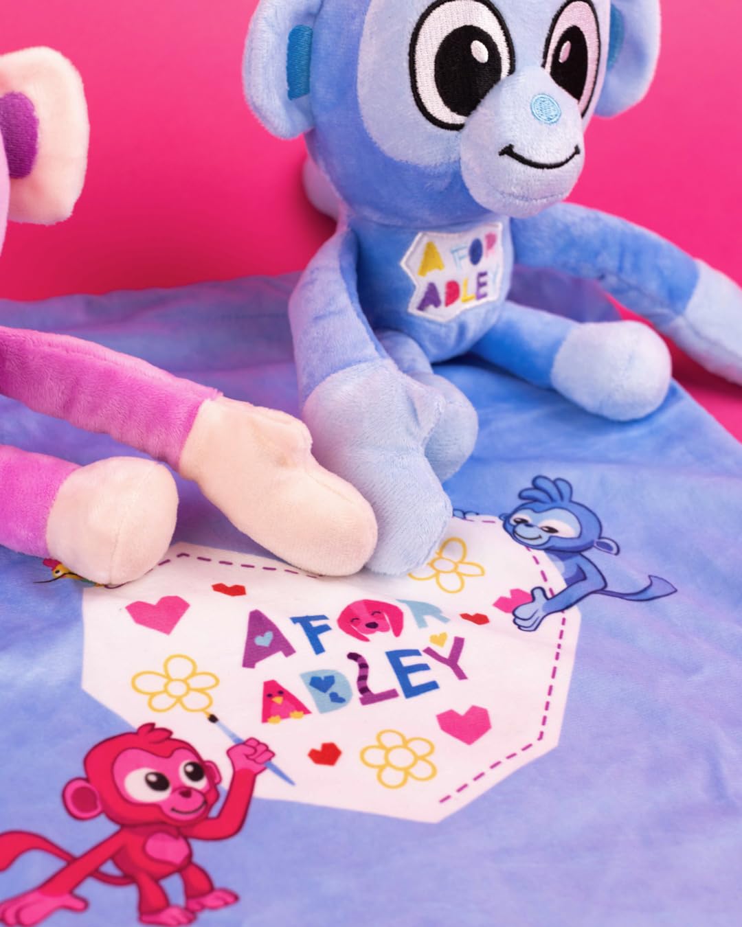 A FOR ADLEY Official Merch Monkey Buddies, A Pink and Blue Monkey Ready to Be Your Favorite Stuffed Animal Friend. Comes with Carrying Bag.