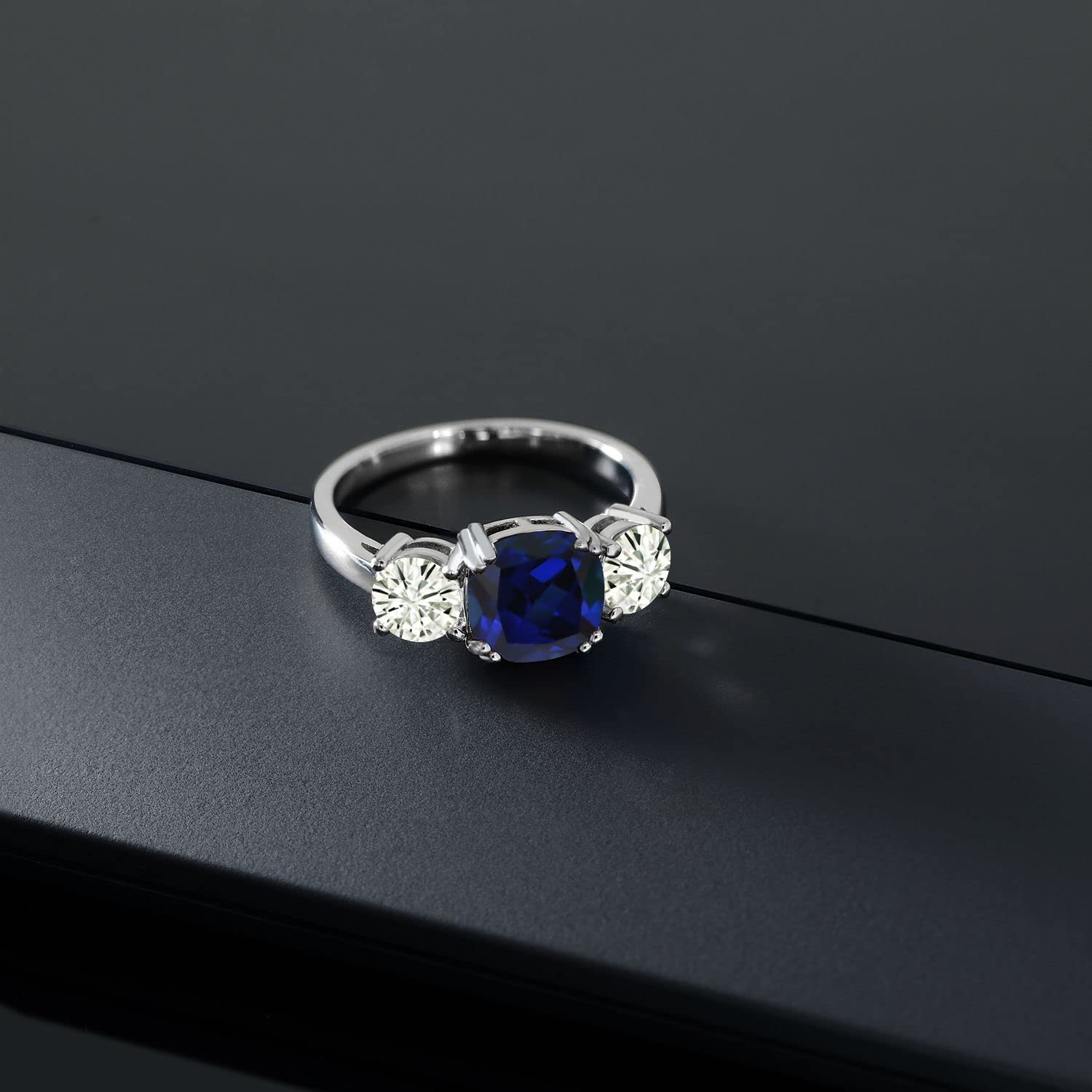 925 Sterling Silver Blue Created Sapphire and Forever Classic Moissanite From Charles & Colvard 3 Stone Engagement Ring For Women (3.50 Cttw, Gemstone September Birthstone, Cushion 8MM, Size 5)