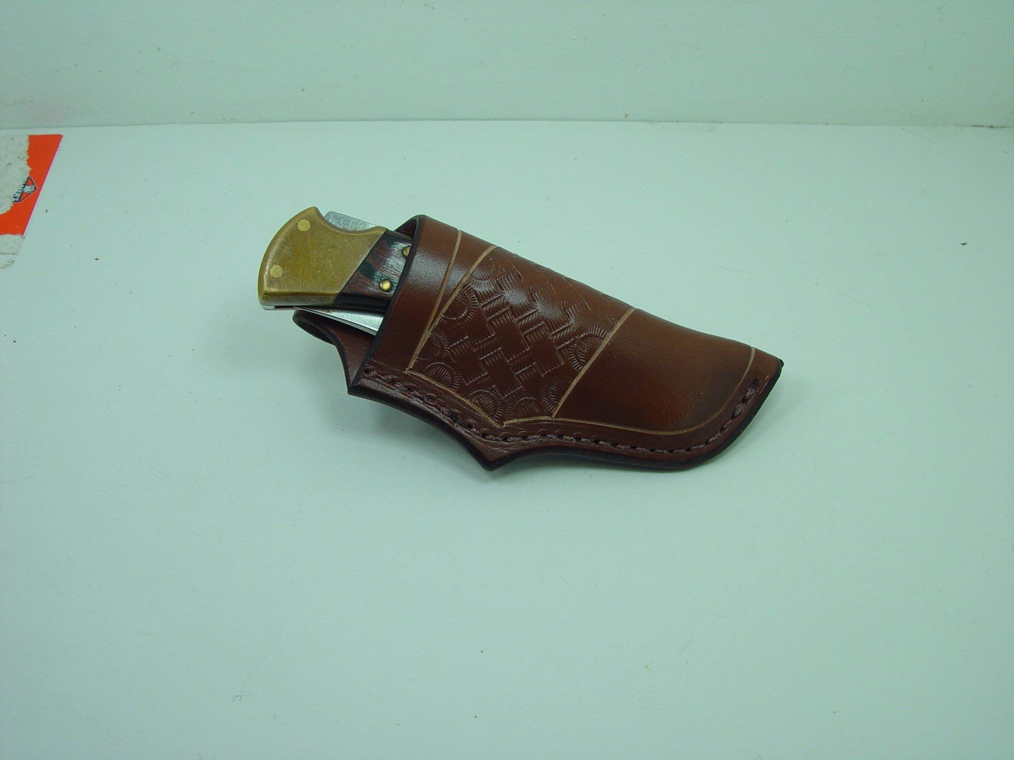 Buck 110 Folding Pocket Knife Sheath. The Sheath Is Made Out of 9 Ounce Leather. . The Sheath Is Died Light Brown with a Basket Weave Tooling. This I for Sheath Only Knife Not Included.
