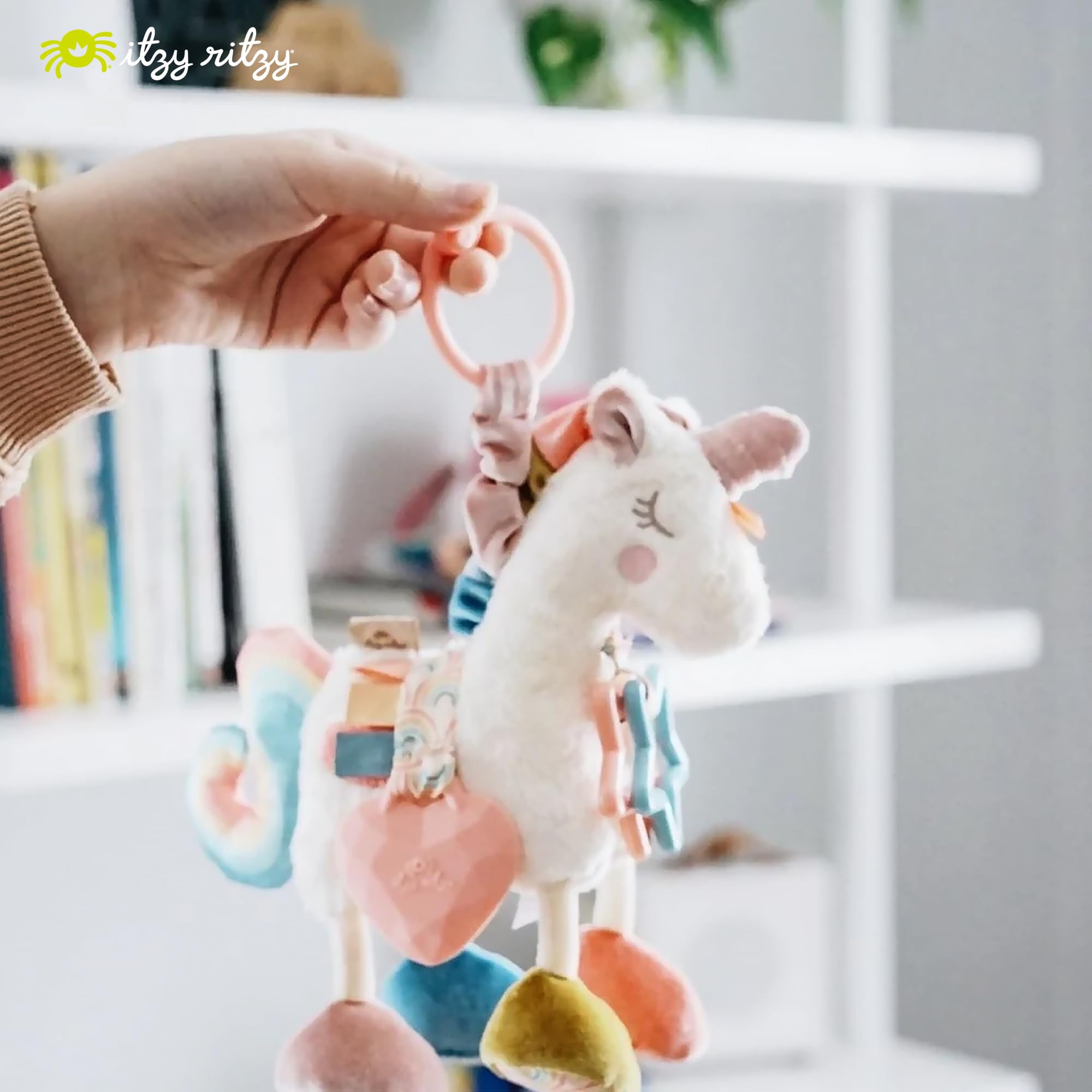 Itzy Ritzy Link & Love Toy for Stroller or Car Seat; Features Textured Ribbons, Crinkle Sounds, Clinking Rings & Silicone Teether; Designed For Ages 0 Months and Up (Unicorn)