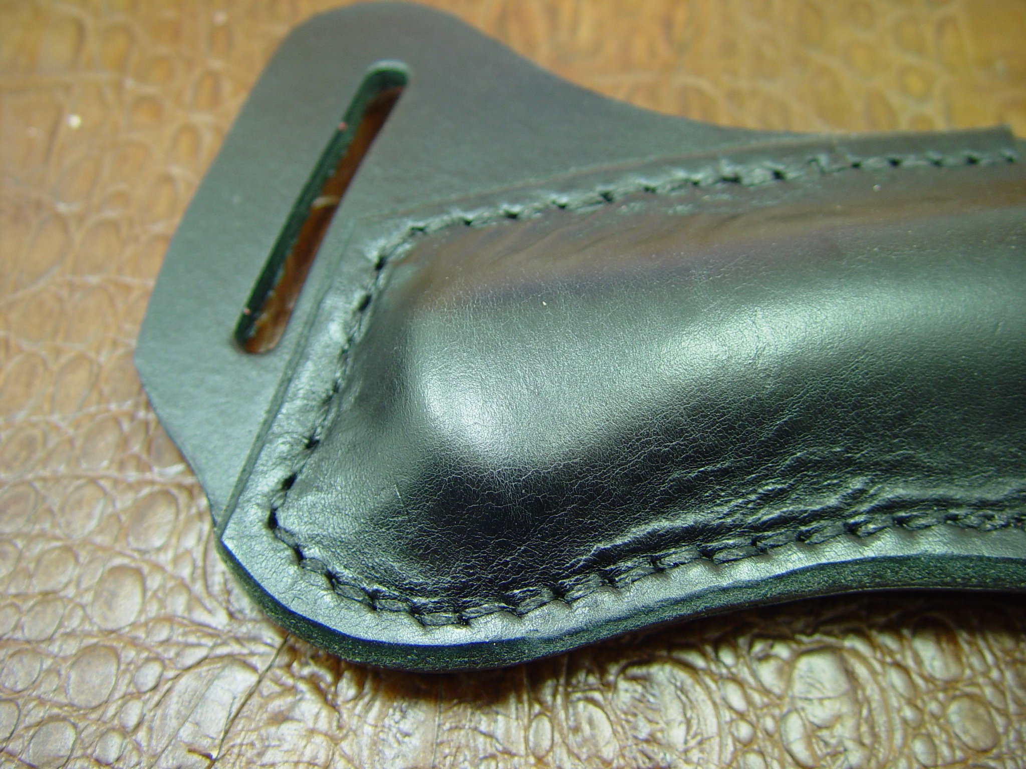 Custom Left Hand Cross Draw Knife Sheath for a Buck 110 Knife. The Sheath is Made Out of Buffalo Hide Leather Dyed Black.