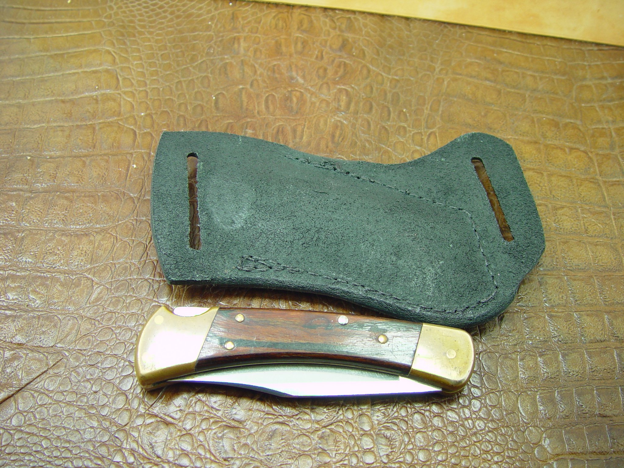 Custom Left Hand Cross Draw Knife Sheath for a Buck 110 Knife. The Sheath is Made Out of Buffalo Hide Leather Dyed Black.