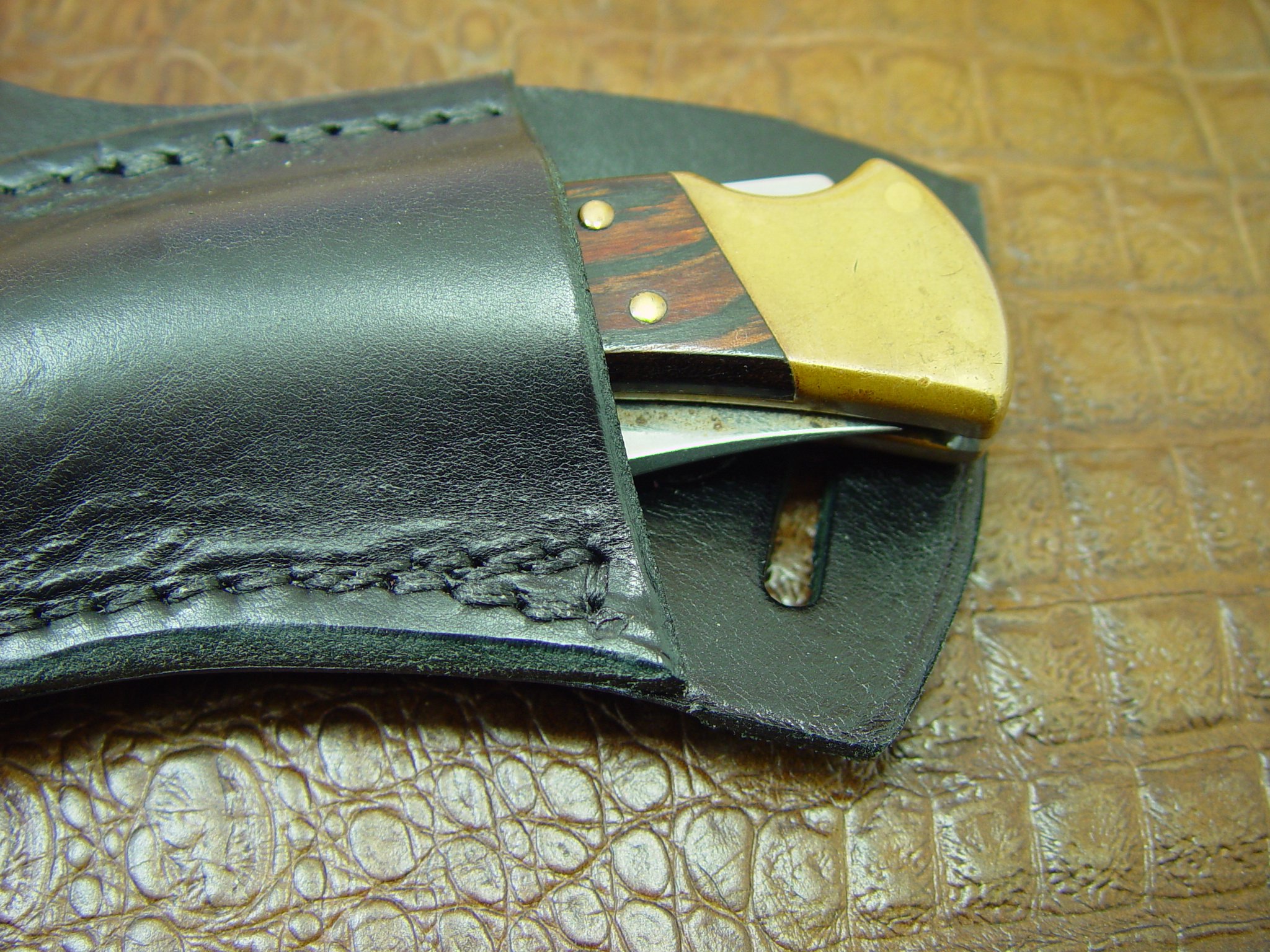 Custom Left Hand Cross Draw Knife Sheath for a Buck 110 Knife. The Sheath is Made Out of Buffalo Hide Leather Dyed Black.