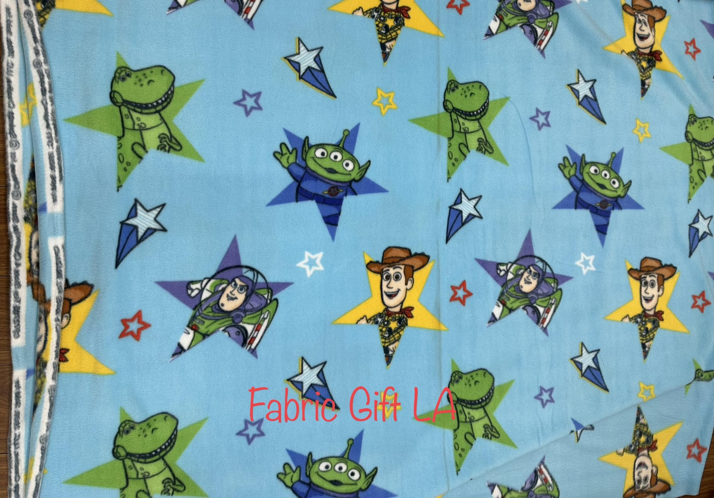 Disney Toy Story 4 Character Stars on Sky Blue Fleece from Springs Creative Buzz Light Year and Woody Fabric by The Yard