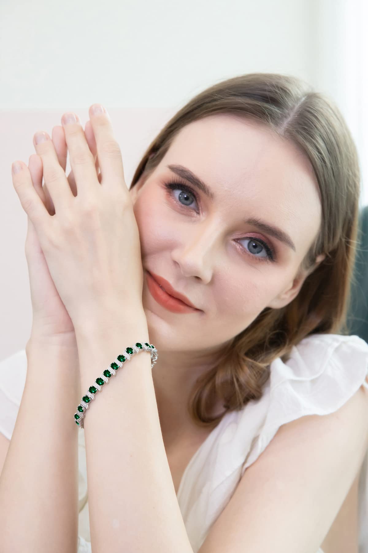 B. BRILLIANT Sterling Silver Simulated Emerald 6x4mm Oval and S Tennis Bracelet with White Topaz Accents