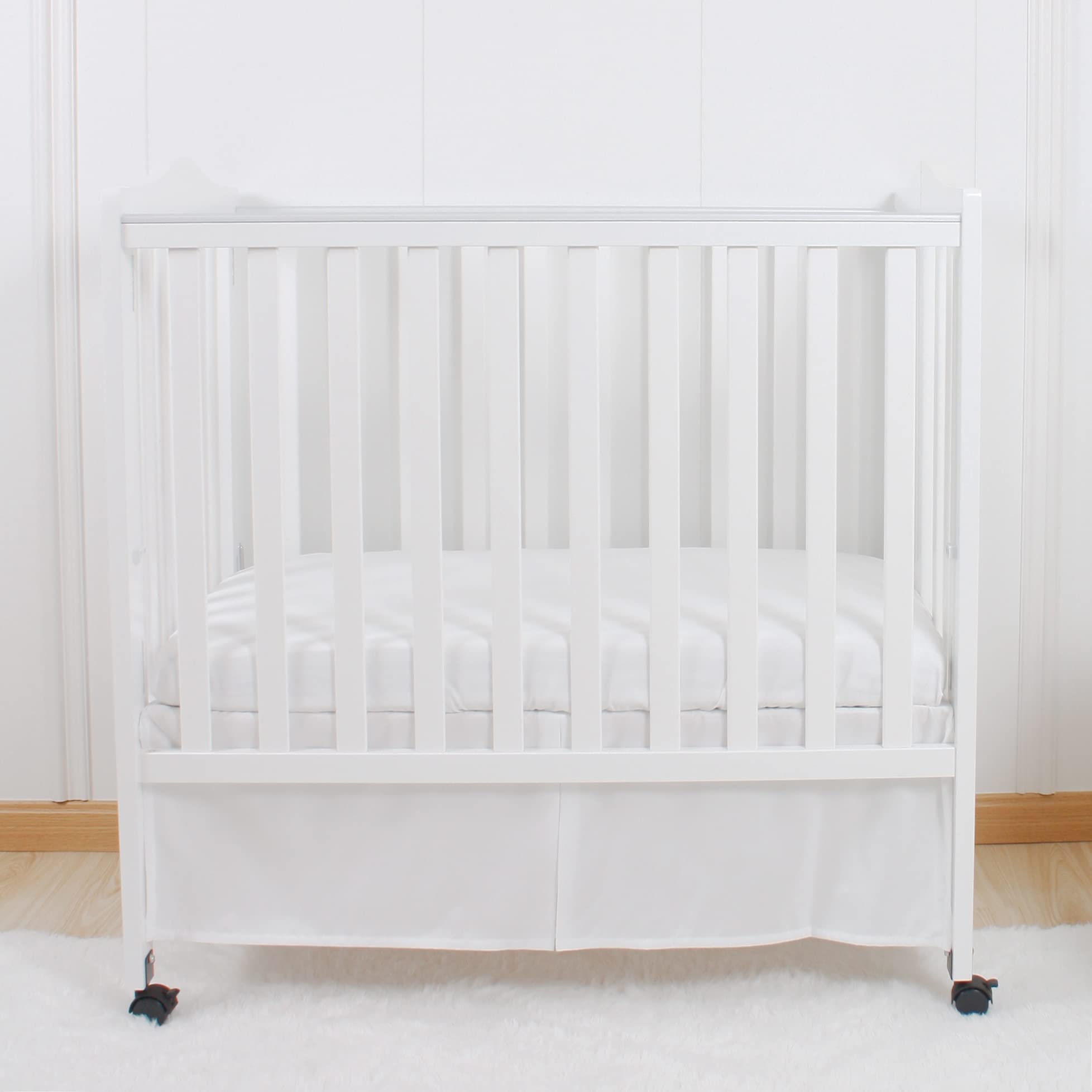 CaSaJa Mini Crib Skirt Pleated, Silk-Looking Soft Microfiber Baby Bed Skirt with Durable Platform for Mini and Portable Cribs 24" X 38", 12" Generous Drop Dust Ruffle, Machine Washable, White Color