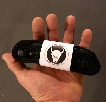 Carrier strap for single or multiple pairs of skis, poles, boots or snowboards