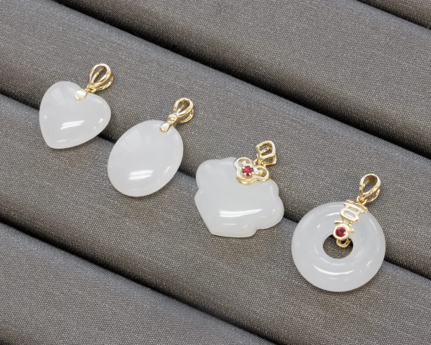 CHOW TAI FOOK Oval Shape Heitian Jade Pendant with 18K Yellow Gold Claws Prong