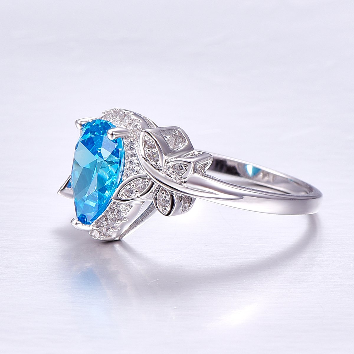 BONLAVIE 3.85ct Created 10 * 8mm Pear Cut Swiss Blue Topaz Ring with CZ Halo Butterfly Teardrop Stackable 925 Sterling Silver Engagement Rings Created Sapphire Rhinestone Ring for Women Size 6