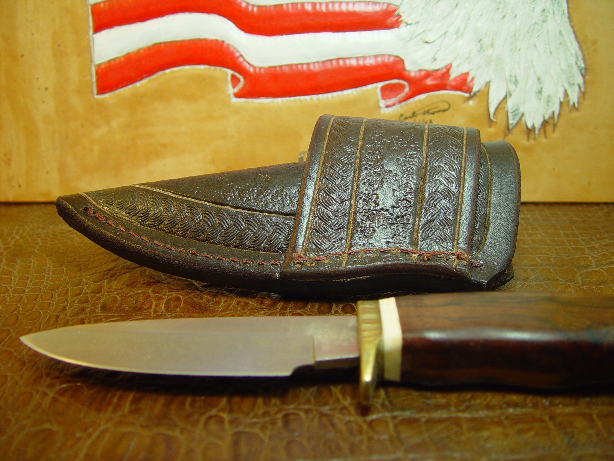 New Buck Vanguard Cross Draw Knife Sheath. Made of 10 Oz Water Buffalo Leather and Has a Rope Pattern Tooling with Random Patterning in the Center of the Sheath. Sheath ONLY!