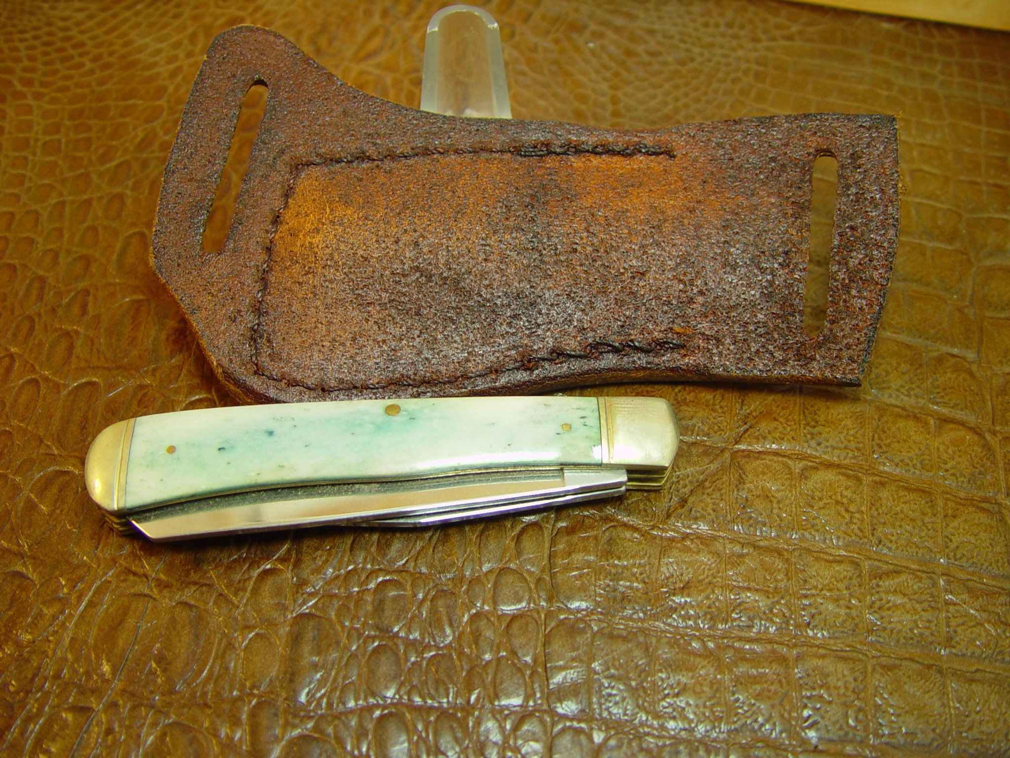 Custom Right-hand Cross Draw Trapper Style Folding Knife Sheath. Made Out of 10 Ounce Buffalo Hide Leather. Dyed Light Brown Sheath Only Knife Not Included.