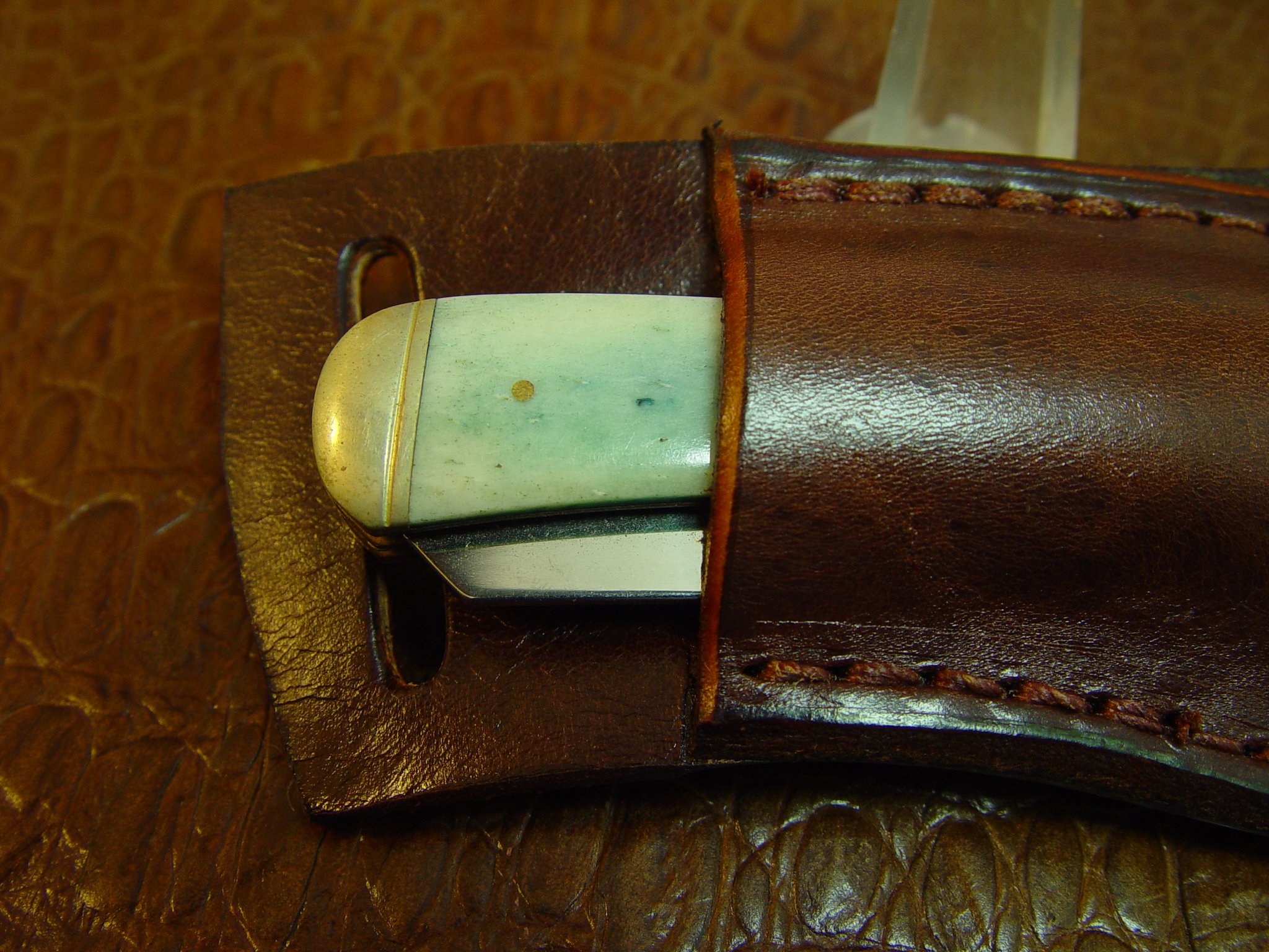 Custom Right-hand Cross Draw Trapper Style Folding Knife Sheath. Made Out of 10 Ounce Buffalo Hide Leather. Dyed Light Brown Sheath Only Knife Not Included.