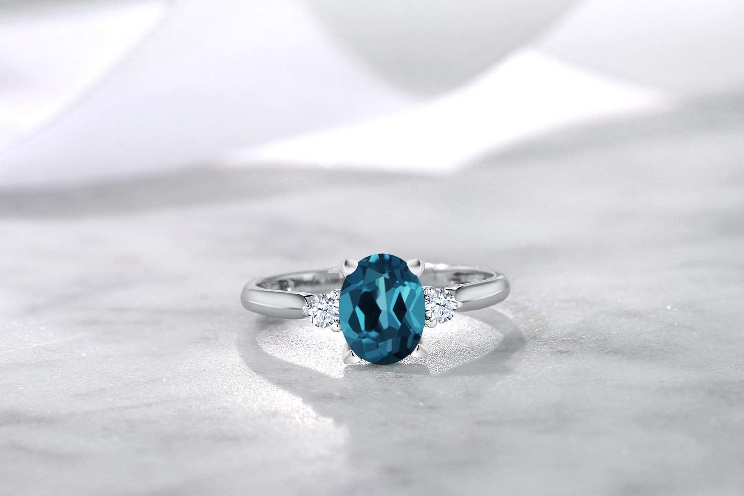 Gem Stone King 10K White Gold London Blue Topaz and White Created Sapphire 3-Stone Women's Ring (1.40 Cttw, Gemstone Birthstone, Available In Size 5, 6, 7, 8, 9)
