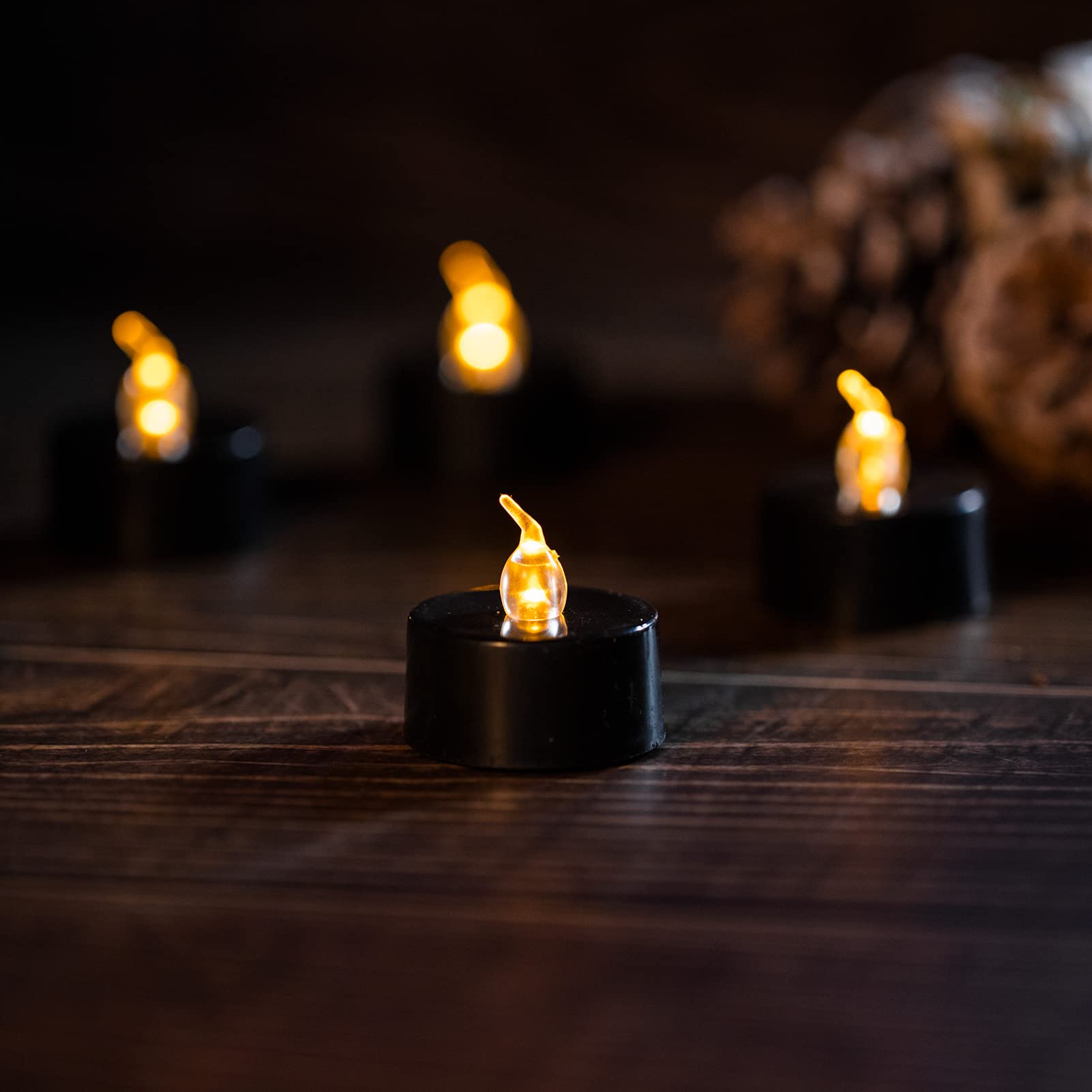 LANKER 24 Pack Black Tea Lights Candles β Flickering Warm Yellow Lights Flameless LED Candles β Long Lasting Battery Operated Fake Candles β Decoration for Wedding, Halloween and Christmas