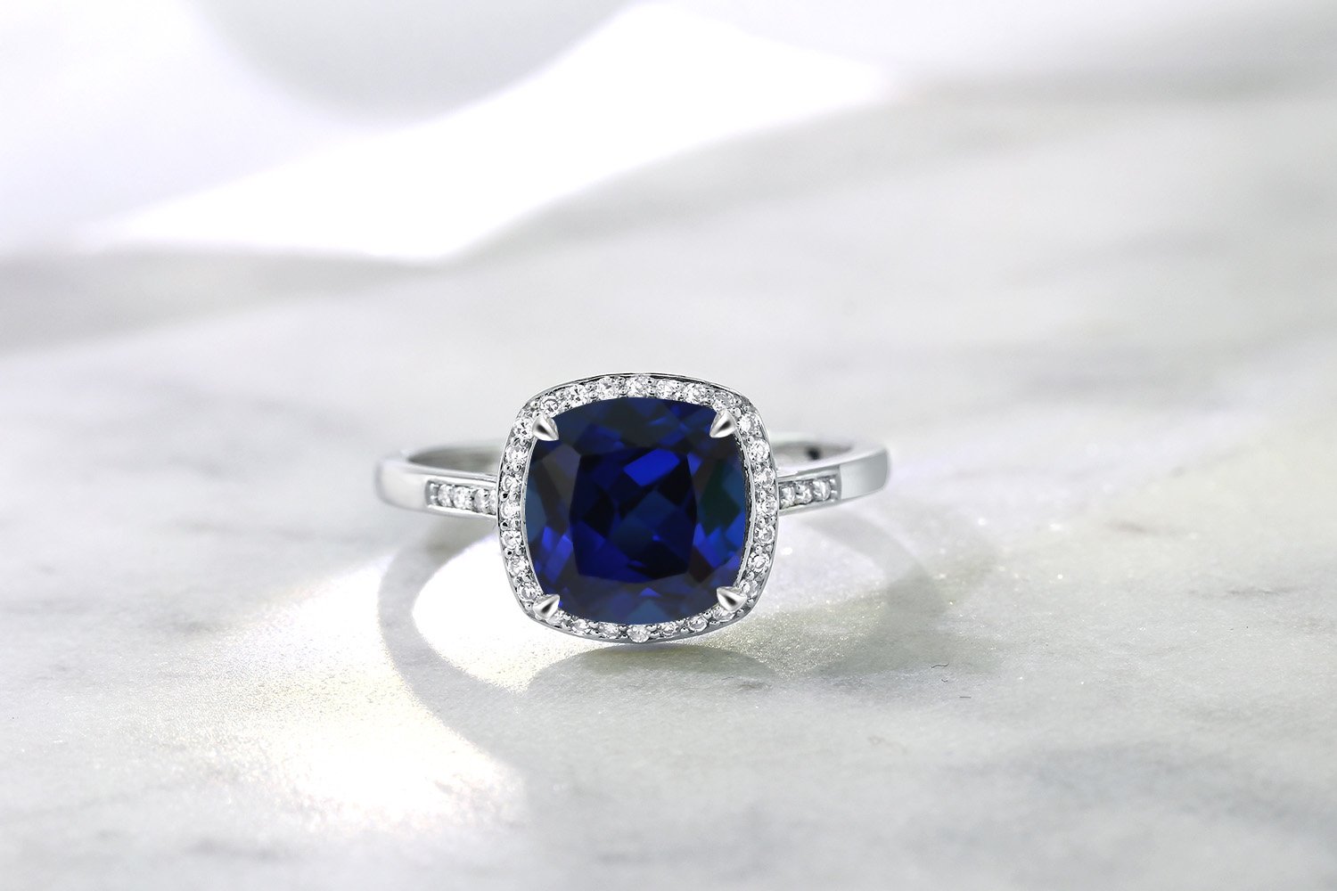 Gem Stone King 10K White Gold Blue Created Sapphire and Accent Diamond Engagement Ring For Women (2.50 Cttw, Cushion 8MM, Available In Size 5, 6, 7, 8, 9)