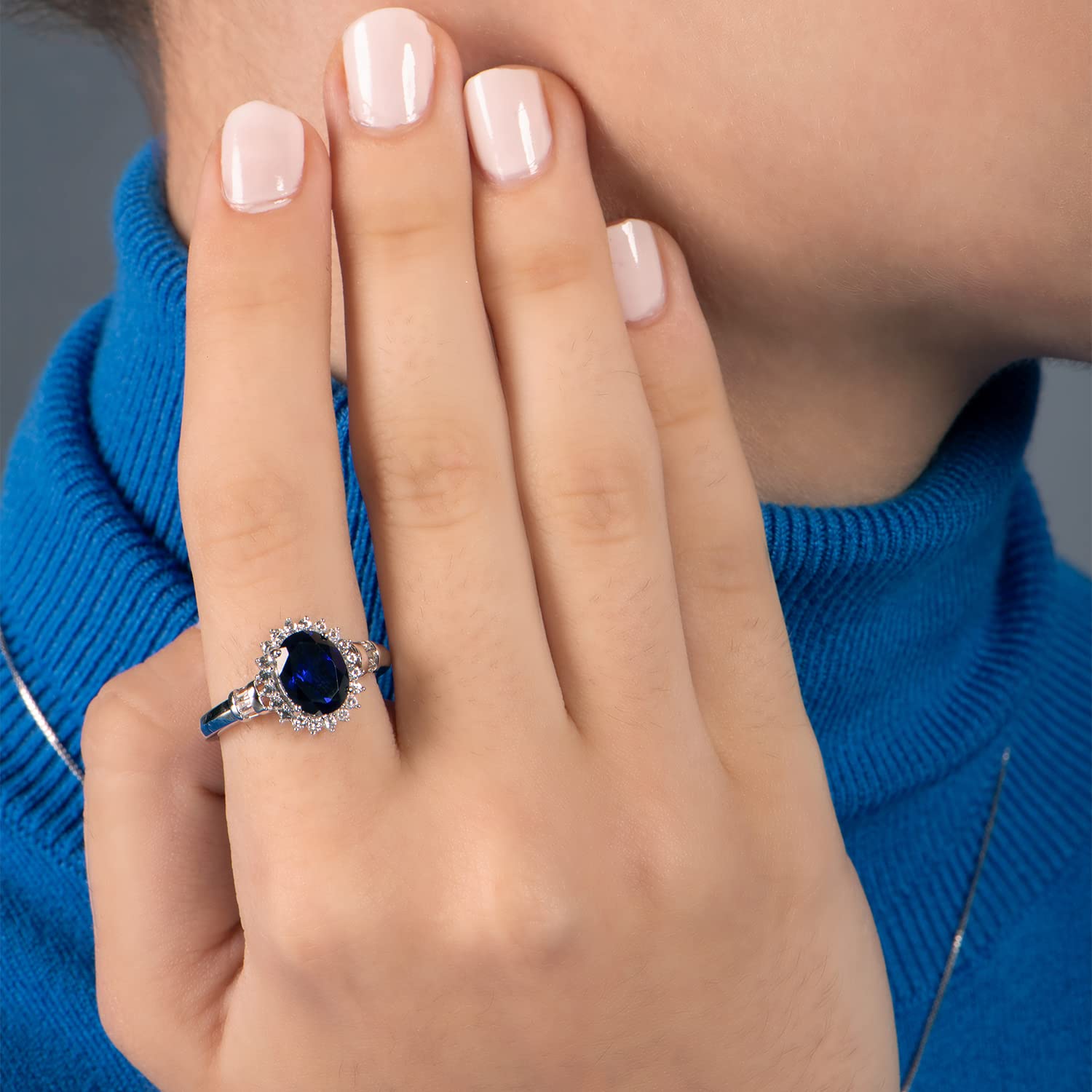 Jewelili Sterling Silver 9X7 MM Oval Created Blue Sapphire with Round and Baguette Created White Sapphire Halo Engagement Ring, Size 7