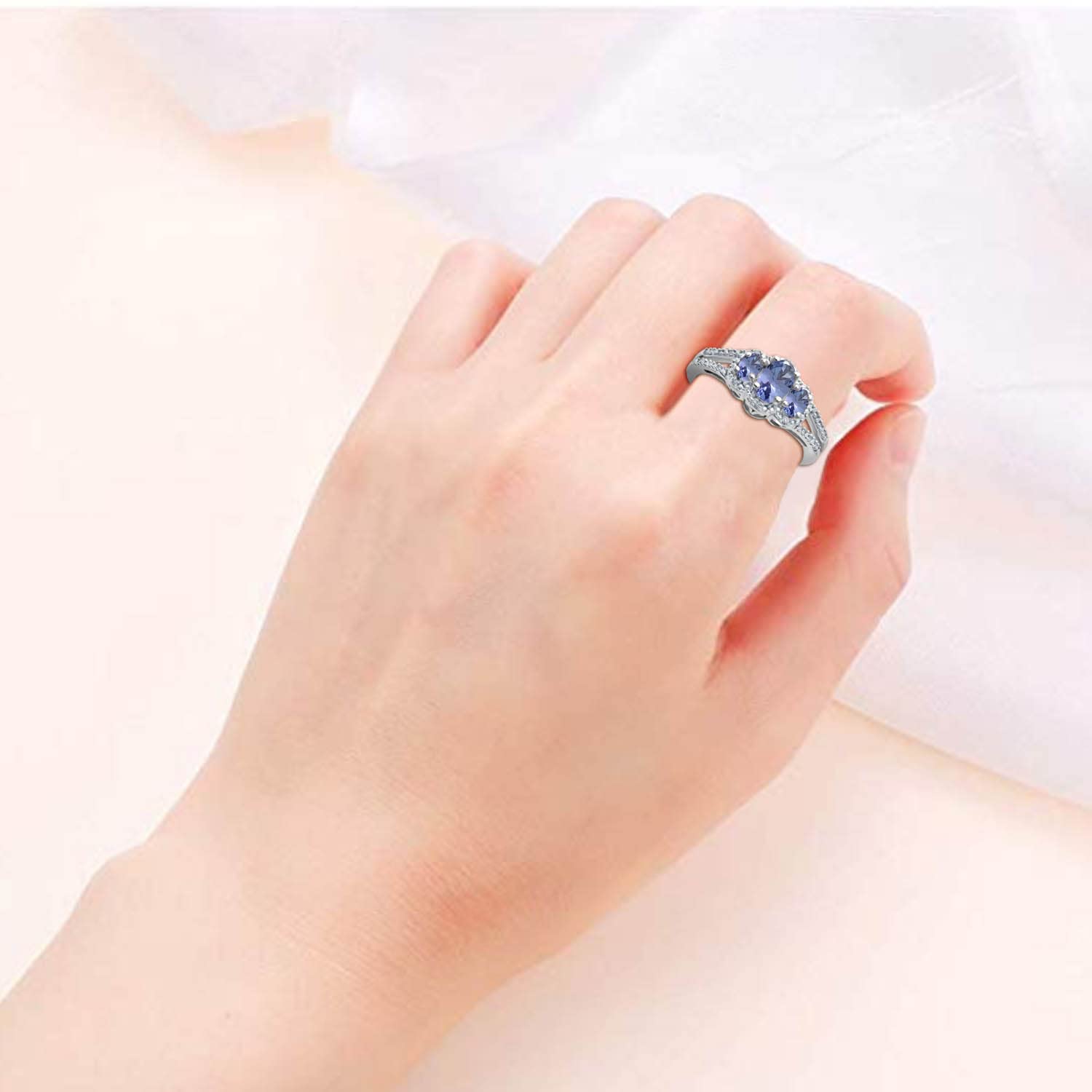 Jewelili Sterling Silver 6x4MM and 4x3MM Oval Shape Tanzanite and Natural White Round Diamond Accent Ring, Size 4