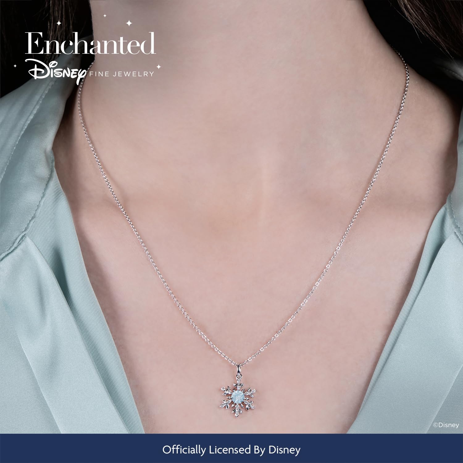 Jewelili Enchanted Disney Fine Jewelry Sterling Silver with 1/8 Cttw Diamonds and Blue Topaz Elsa Snowflake Pendant