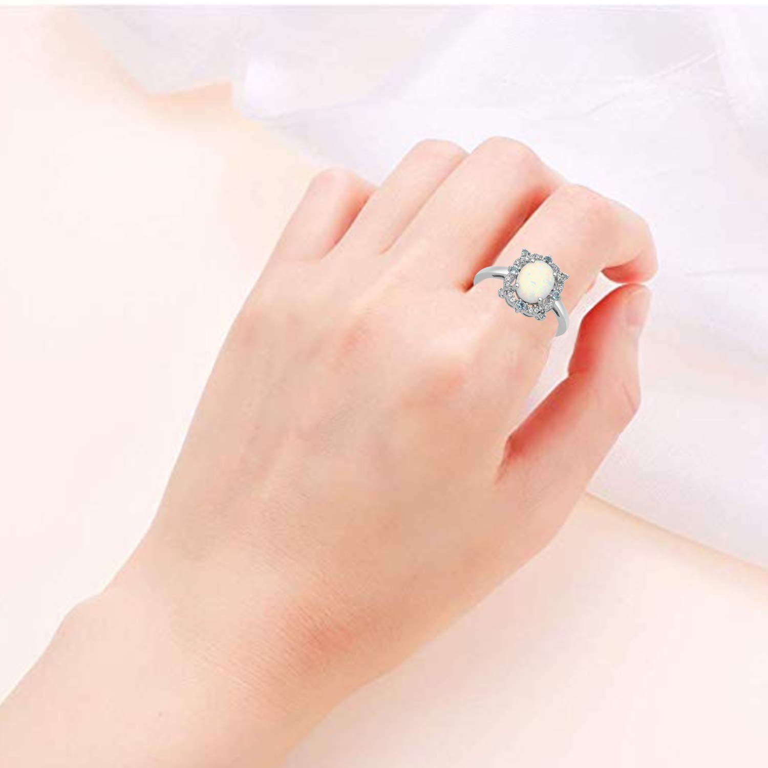 Jewelili Halo Ring in Sterling Silver with Oval Shape Created Opal, Round Swiss Blue Topaz and Created White Sapphire, Size 7