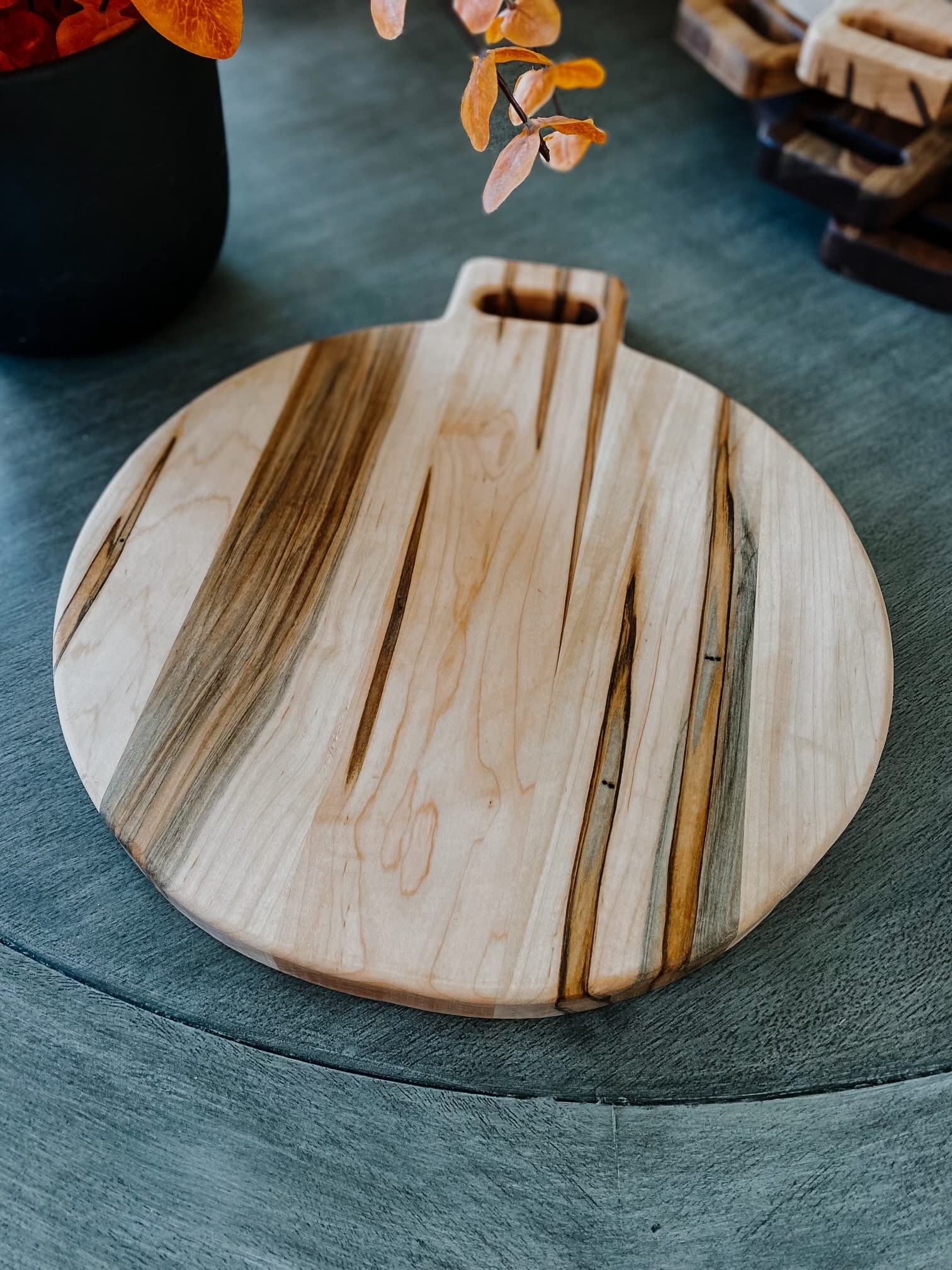 Round charcuterie serving board with handle, handmade in the USA with Maple hardwood.