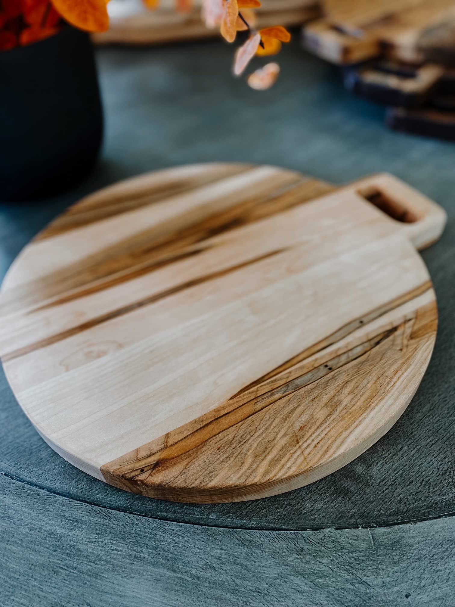 Round charcuterie serving board with handle, handmade in the USA with Maple hardwood.