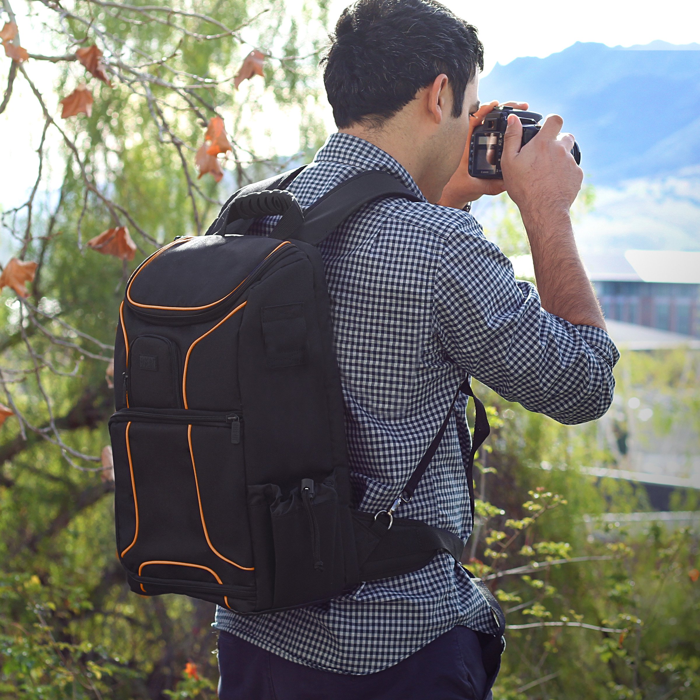 USA Gear DSLR Camera Backpack Case - 15.6 inch Laptop Compartment, Padded Custom Dividers, Tripod Holder, Rain Cover, Long-Lasting Durability and Storage Pockets - Compatible with Many DSLRs (Orange)