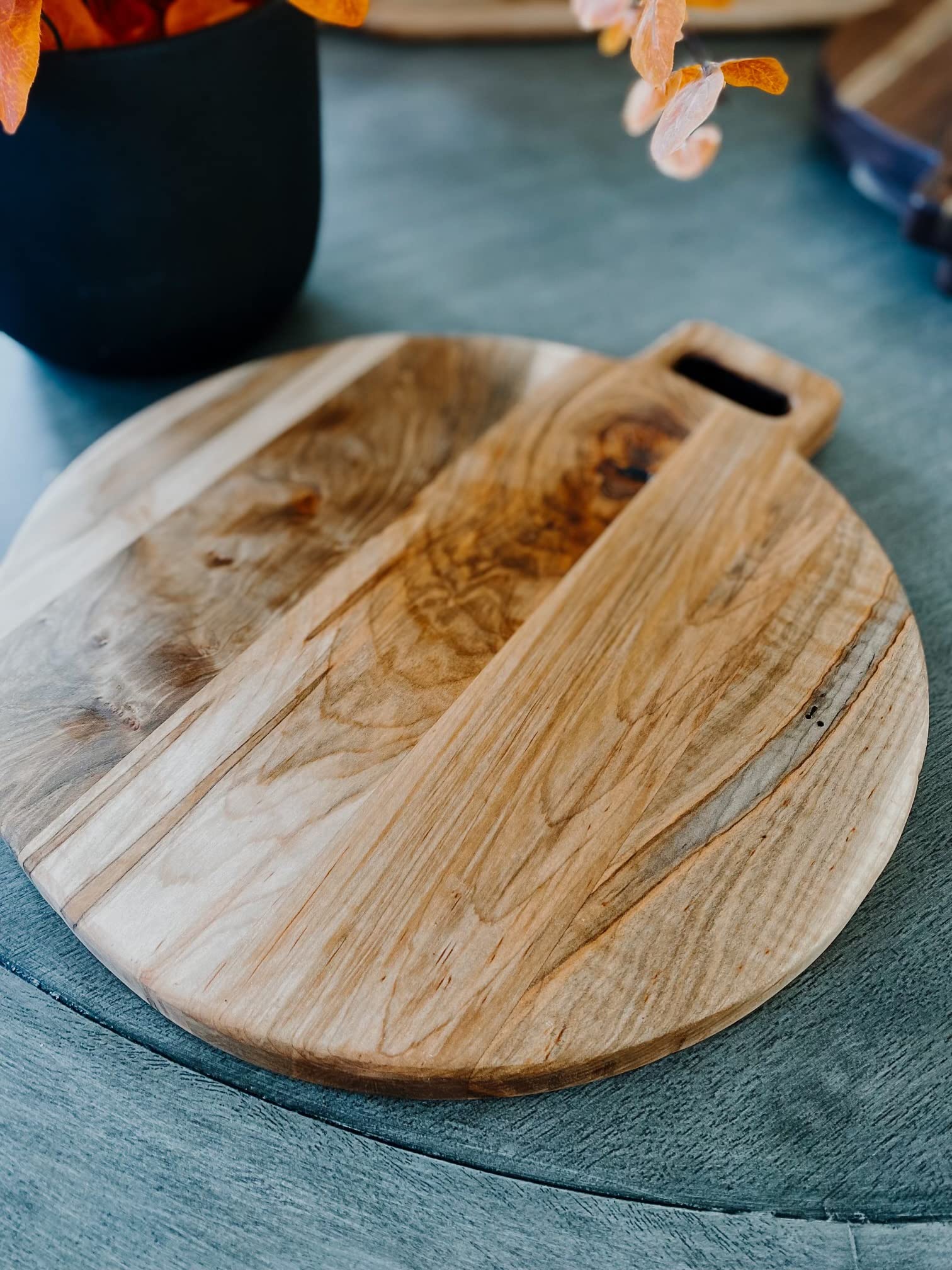 Round charcuterie serving board with handle, handmade in the USA with Maple hardwood.