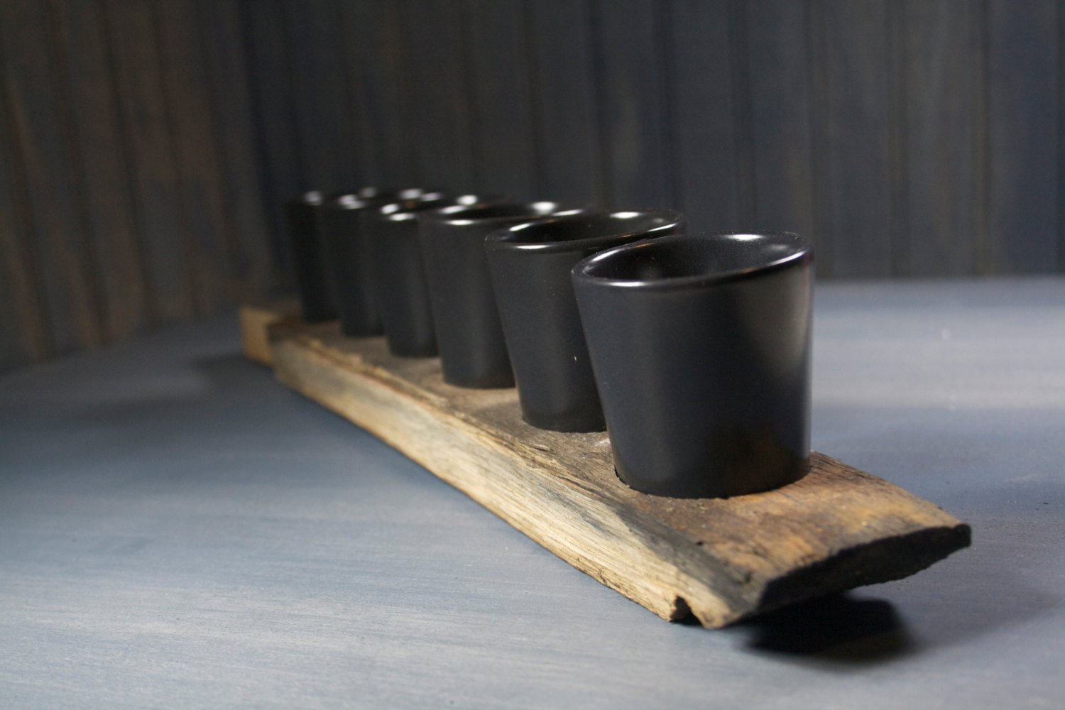 WHISKEY BARREL SHOT PADDLE WITH BLACK CERAMIC SHOT GLASSES - Black Ceramic shot glasses with a reclaimed whiskey barrel shot paddle and leather handle, 6 shot glasses/sake cups included