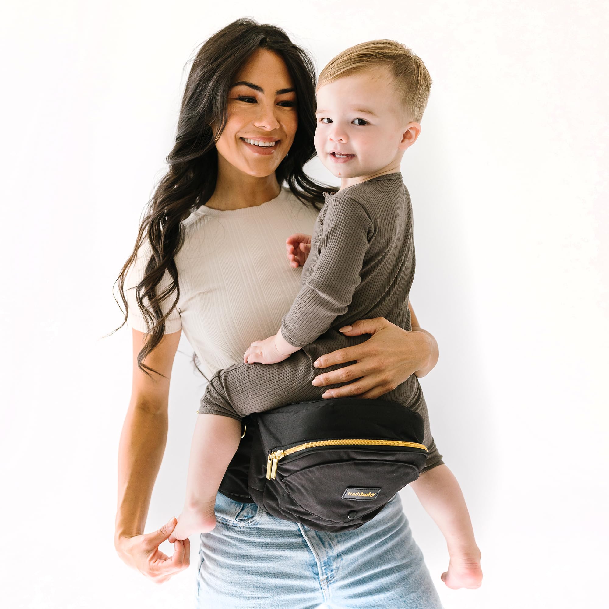 Tushbaby - Safety-Certified Hip Seat Baby Carrier - Momâs Choice Award Winner, Seen on Shark Tank, Ergonomic Carrier & Extenders for Newborns & Toddlers (Carrier, Black/Gold)