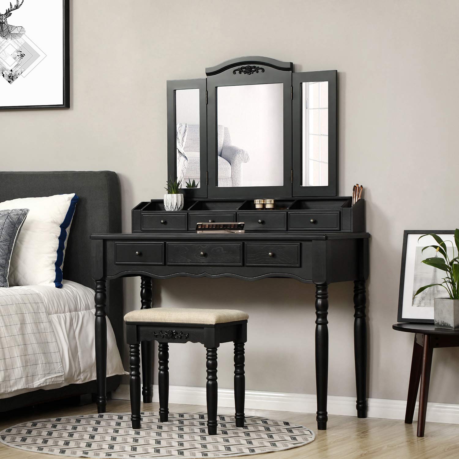 VASAGLE Vanity Makeup Set with 7 Drawers, 2 Brush Slots and 4 Open Compartments, Dressing Table with Tri-Fold Necklace Hooked Mirror, Solid Wood Legs, Cushioned Stool, Black URDT06BK